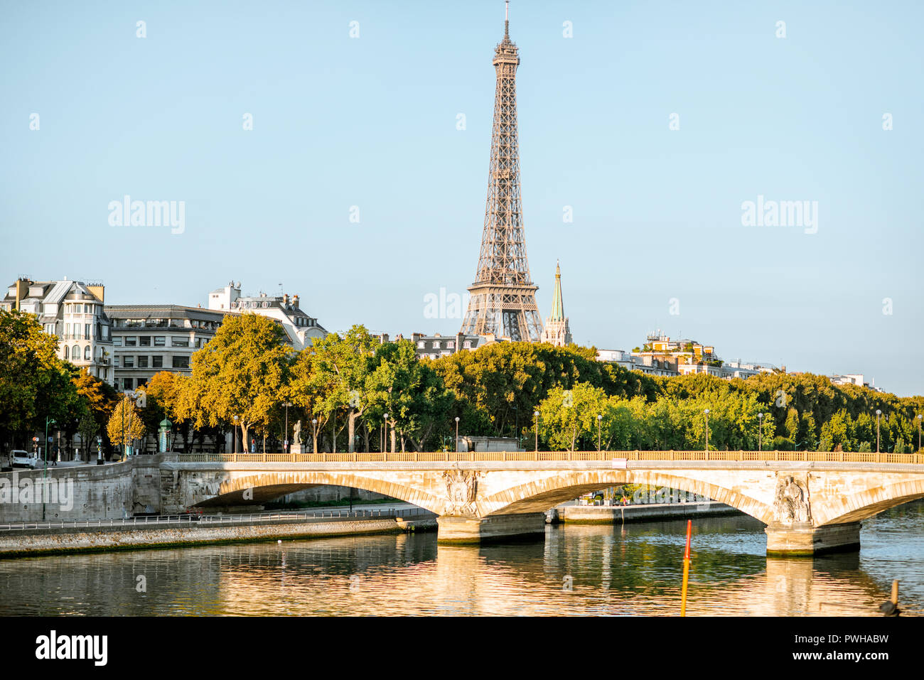 Landscape view of the riverside with Eiffel tower during the morning ...