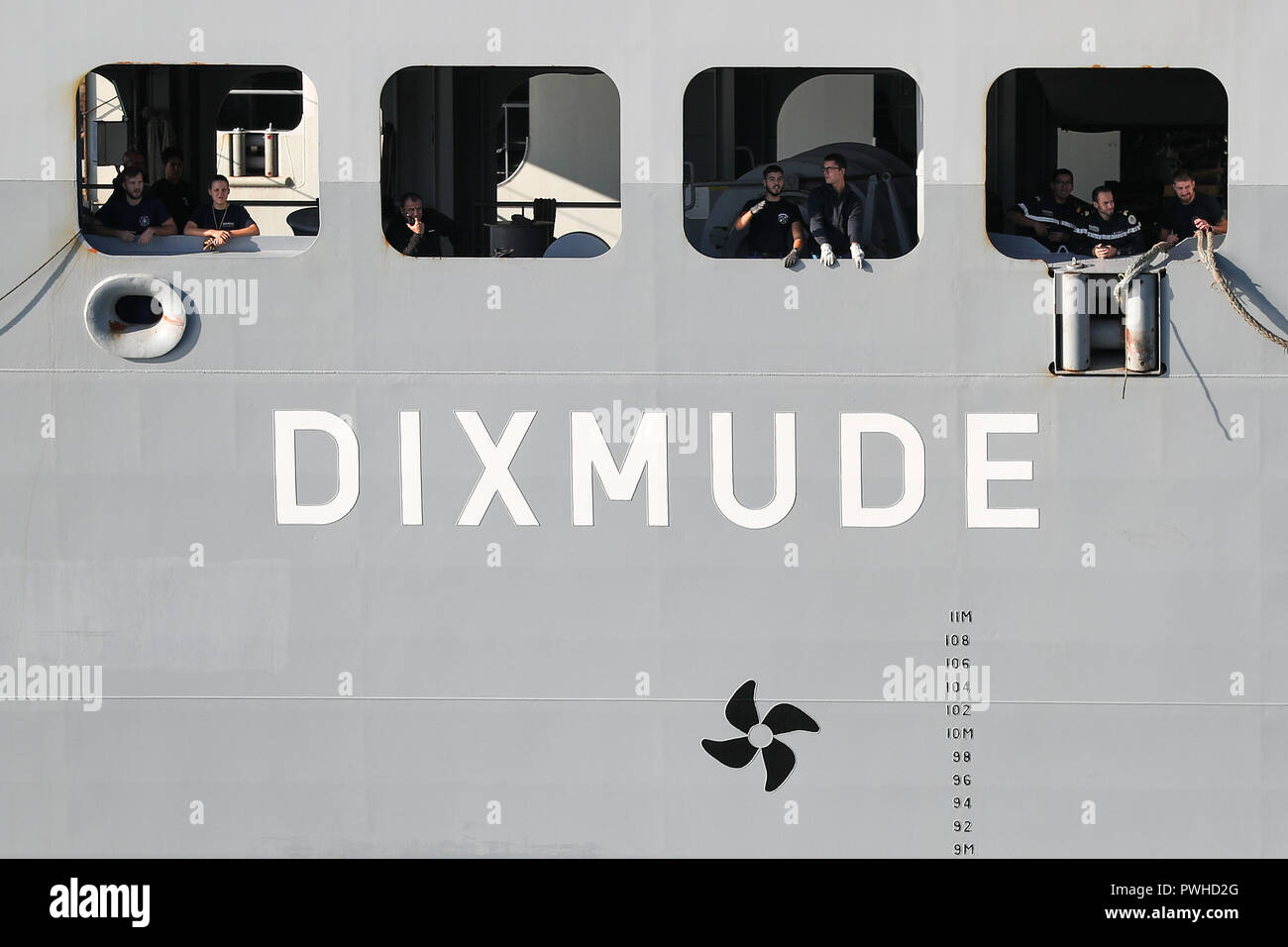 Crew look out from the ship as the French Navy amphibious assault ship ...