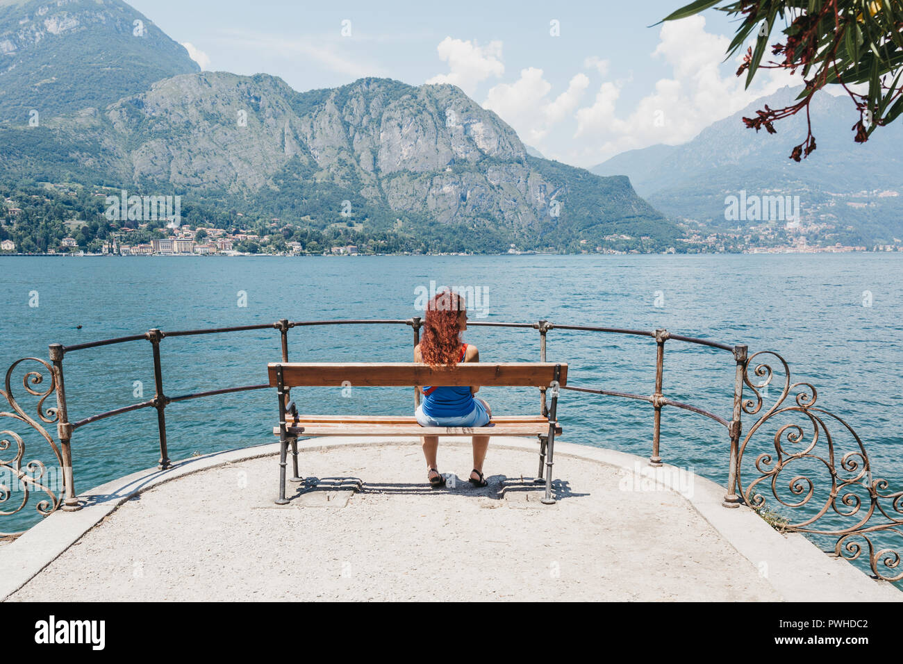 Bellagio, Italy - July 06, 2017: Woman relaxing on a bench in Bellagio ...