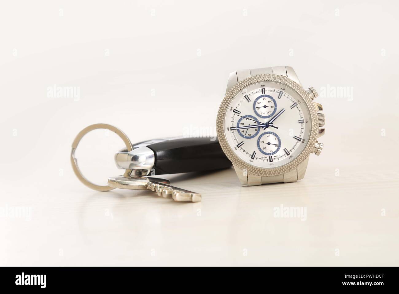 Picture of wrist watch and car key on white background Stock Photo - Alamy