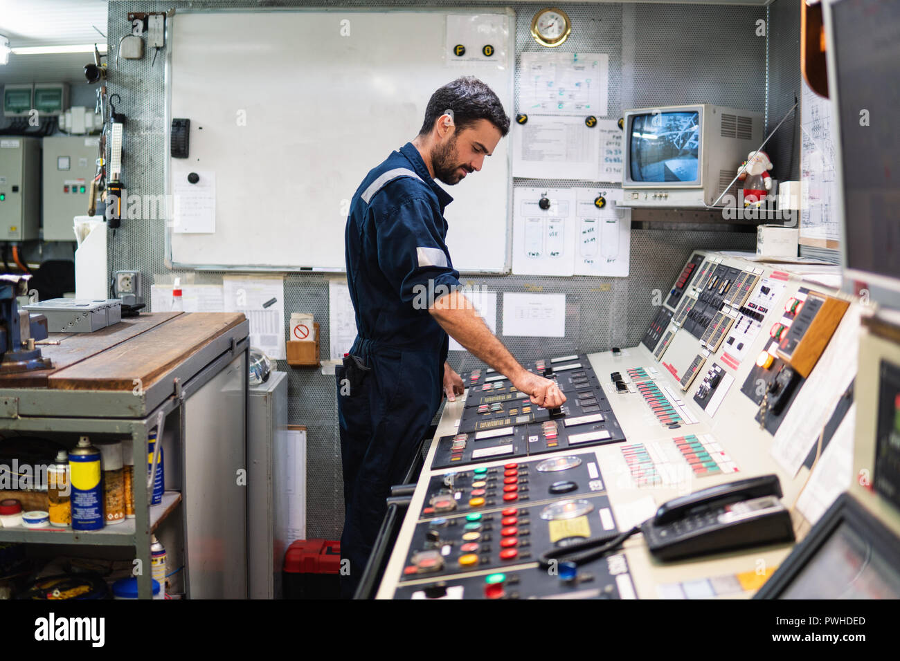 Marine engineer officer working in engine room Stock Photo - Alamy