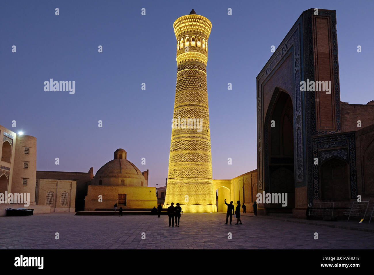 View of the illuminated Kalon Minaret built by the Karakhanid ruler ...