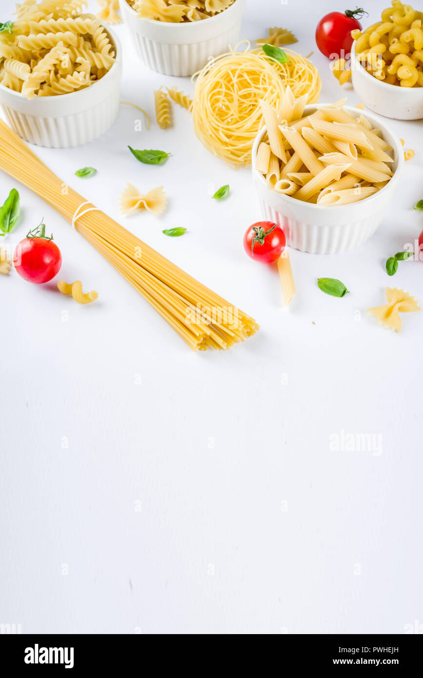 Italian food concept, various raw pasta assortment - spaghetti, lasagna ...