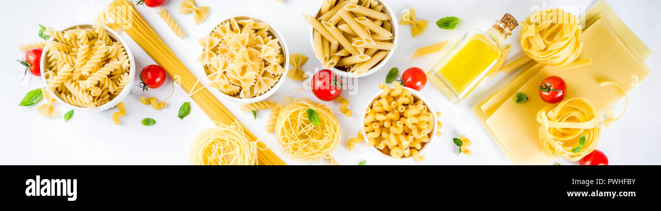Italian food concept, various raw pasta assortment - spaghetti, lasagna ...