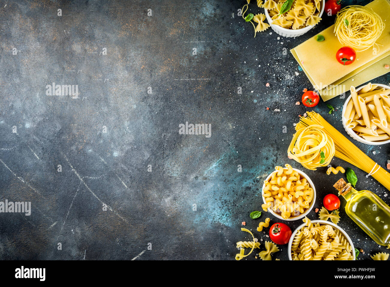 Italian food concept, various raw pasta assortment - spaghetti, lasagna ...