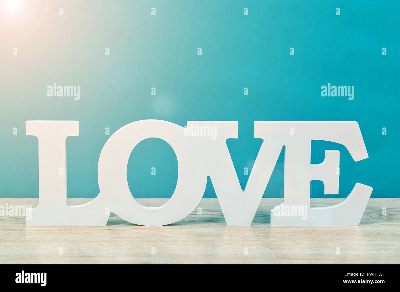 White wooden word love on blue background Stock Photo - Alamy