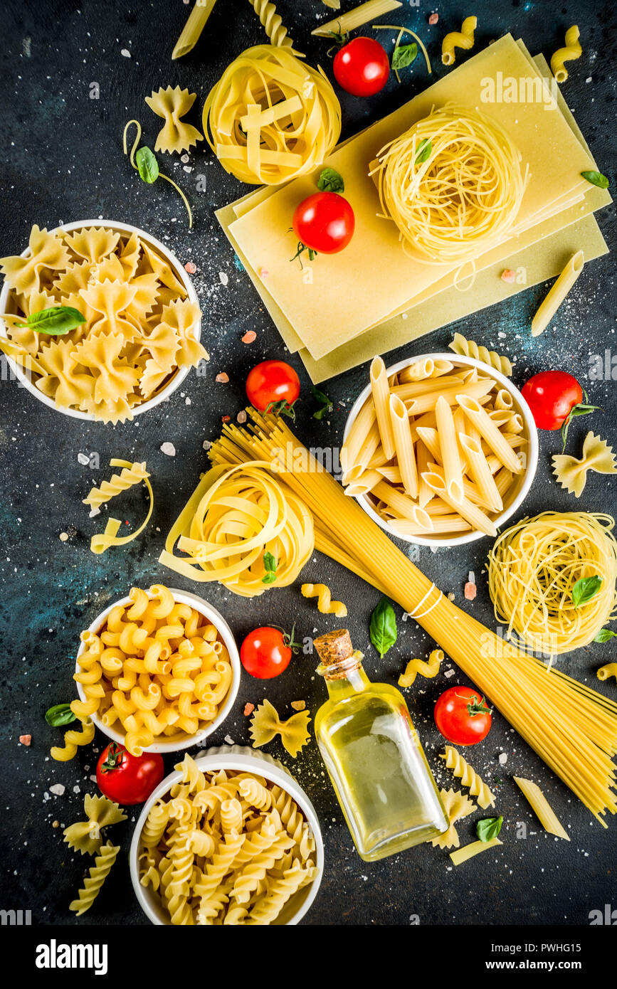 Italian food concept, various raw pasta assortment - spaghetti, lasagna ...