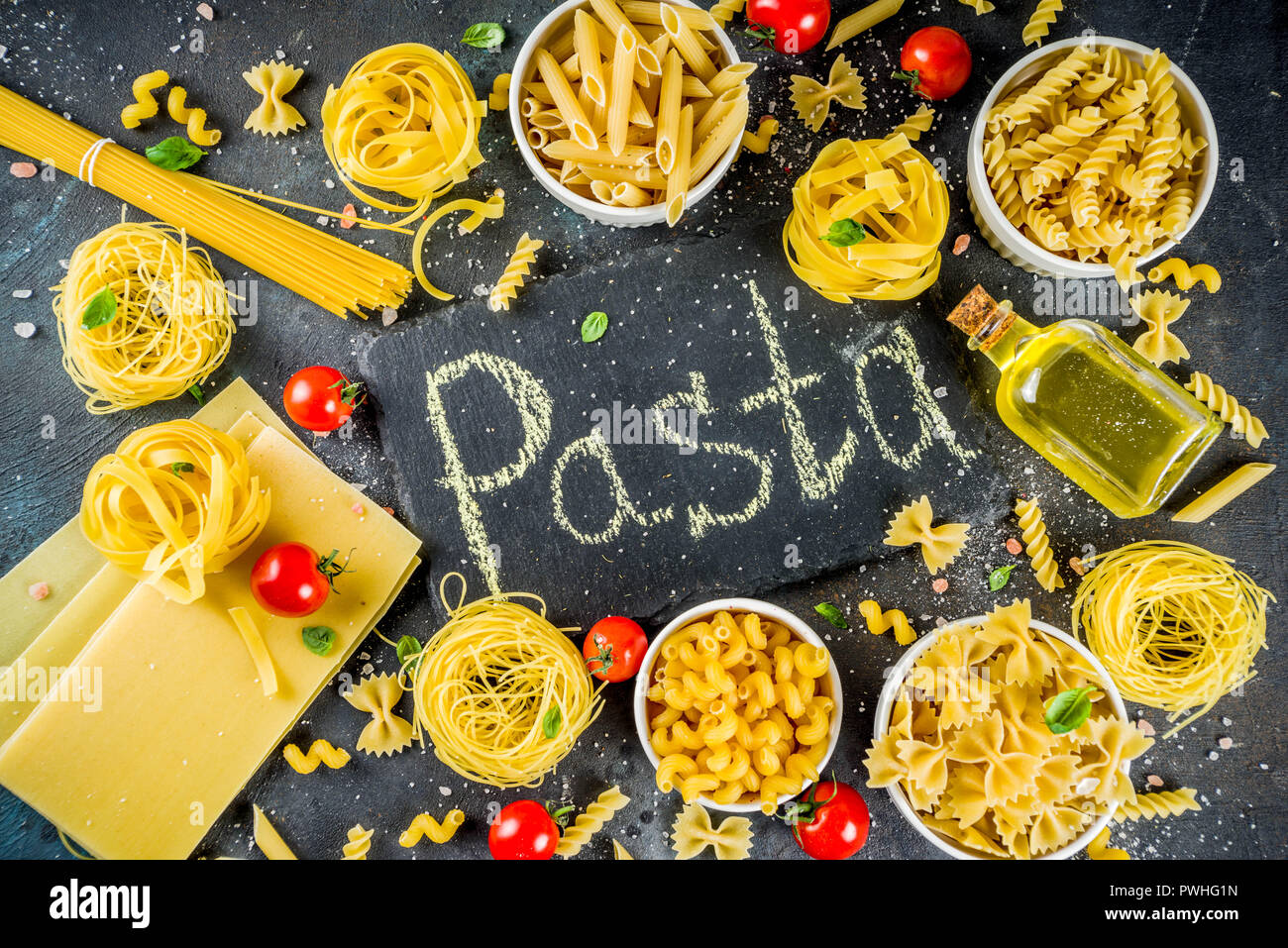 Italian food concept, various raw pasta assortment - spaghetti, lasagna ...