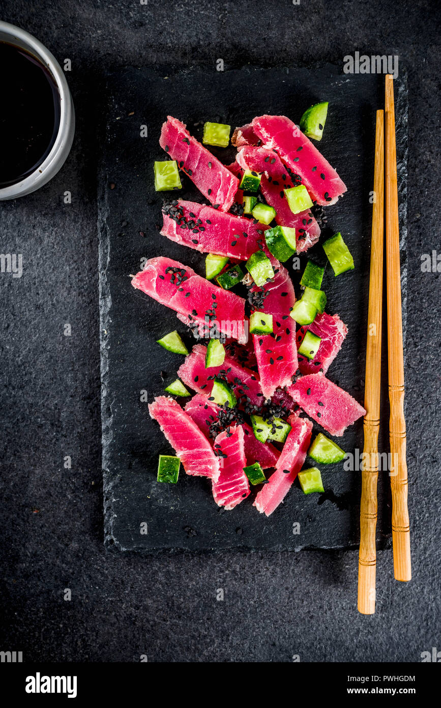Tuna sashimi poke with raw fresh fish, cucumber, black sesame seeds and ...