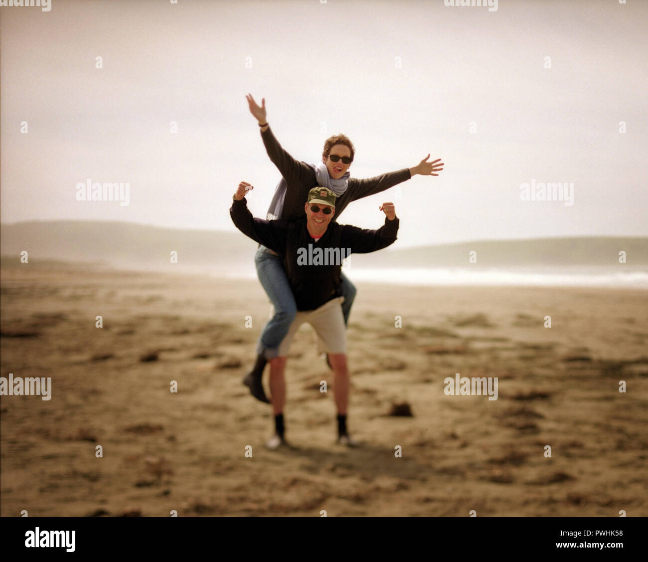 Front view of an ecstatic couple on a beach Stock Photo - Alamy