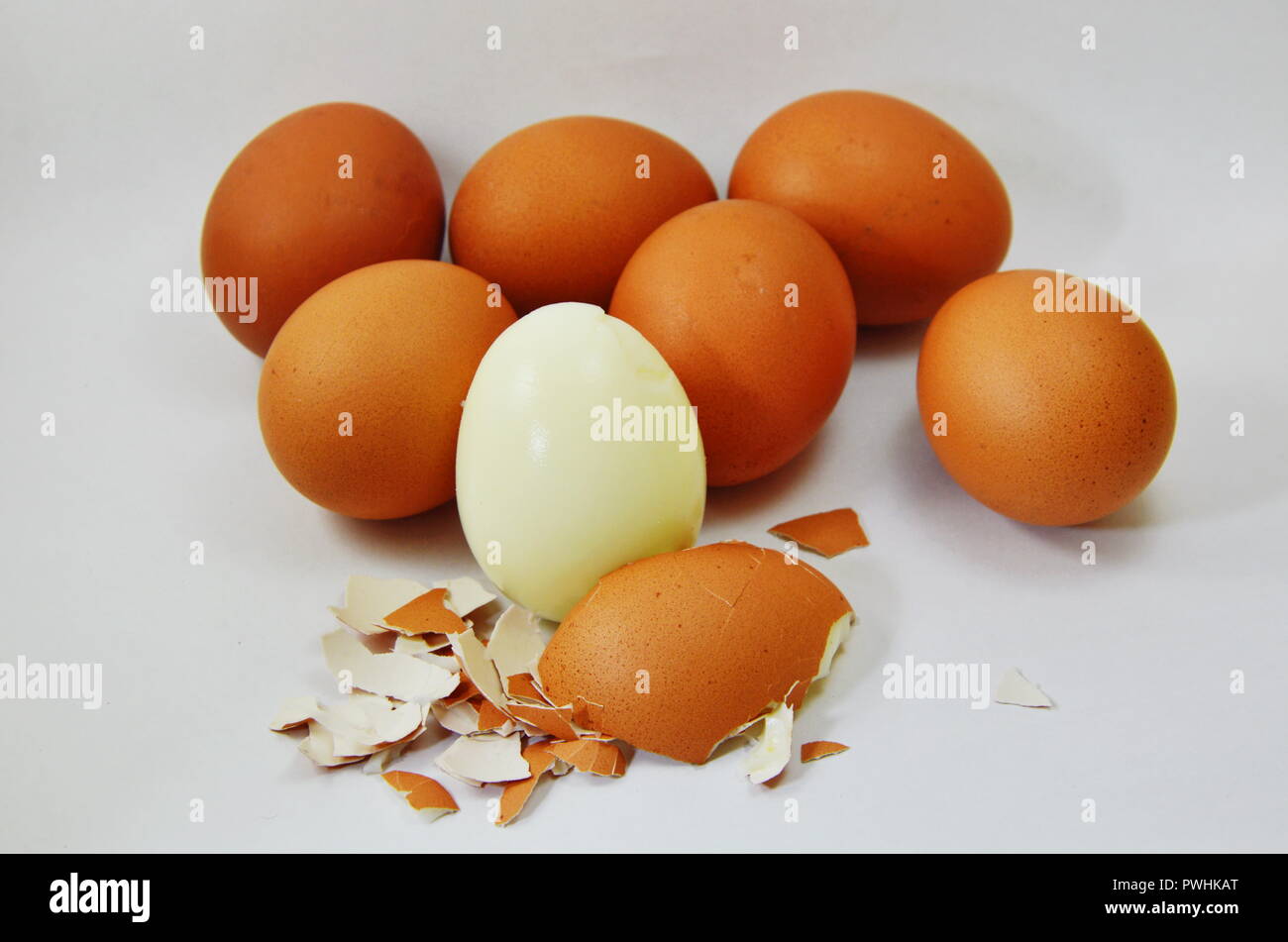 boiled egg peel shell out on white background Stock Photo - Alamy