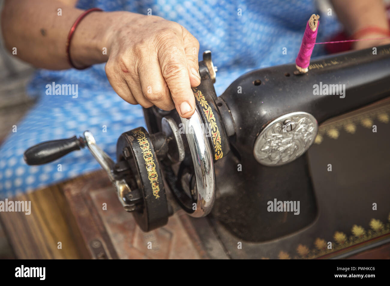 Women using sewing machine close hi-res stock photography and images ...