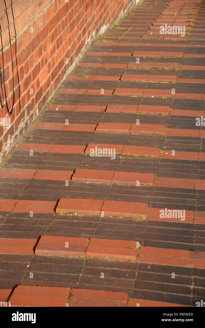 Raised brickwork on canal towpath in Birmingham city dntre which was ...