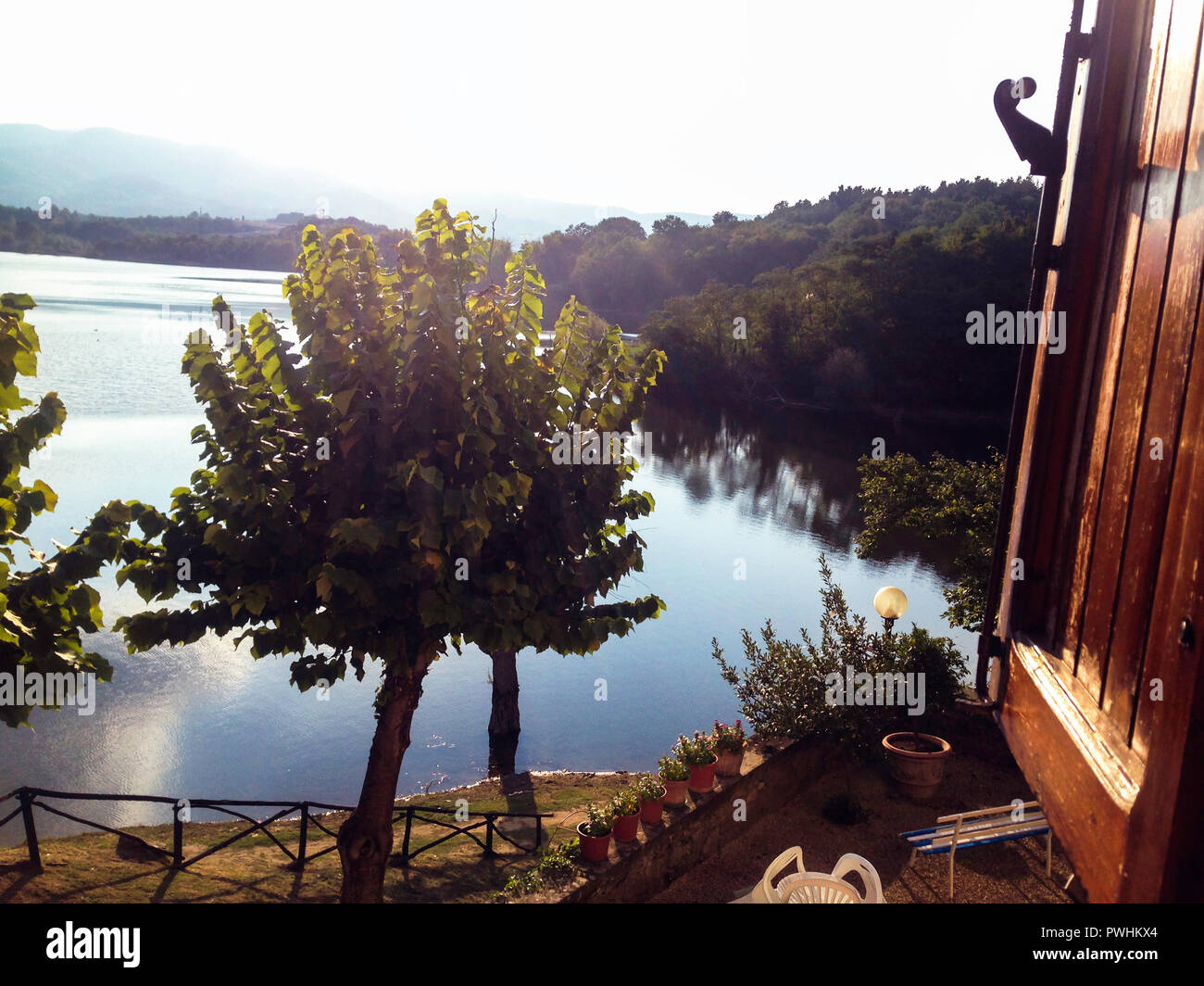 View through the window of a lake and a forest Stock Photo - Alamy