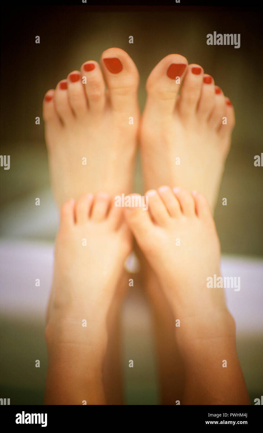Pair of baby feet resting on top of a lady?s feet Stock Photo - Alamy
