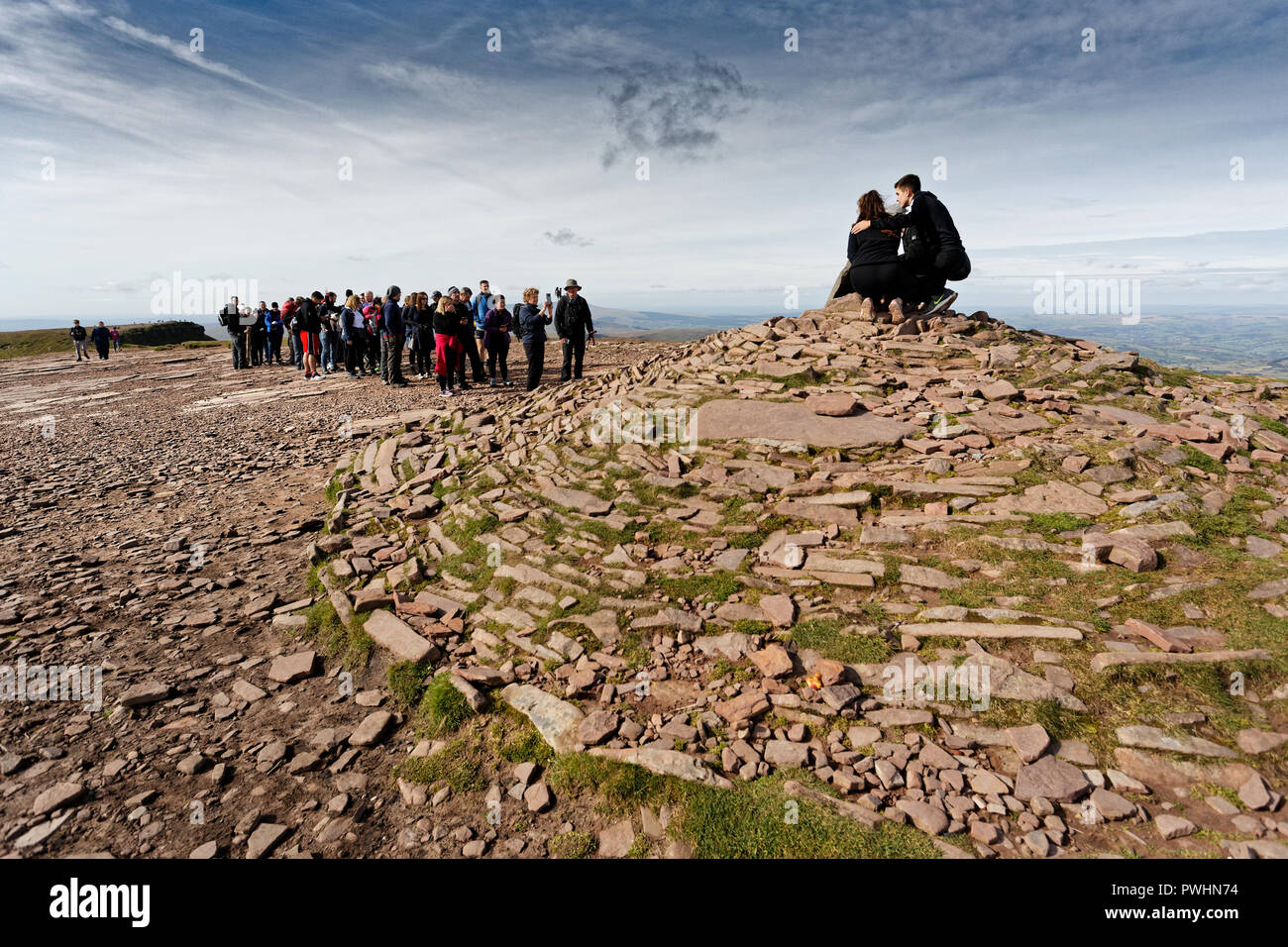 Pictured: People queue to have their picture taken by the plinth ...