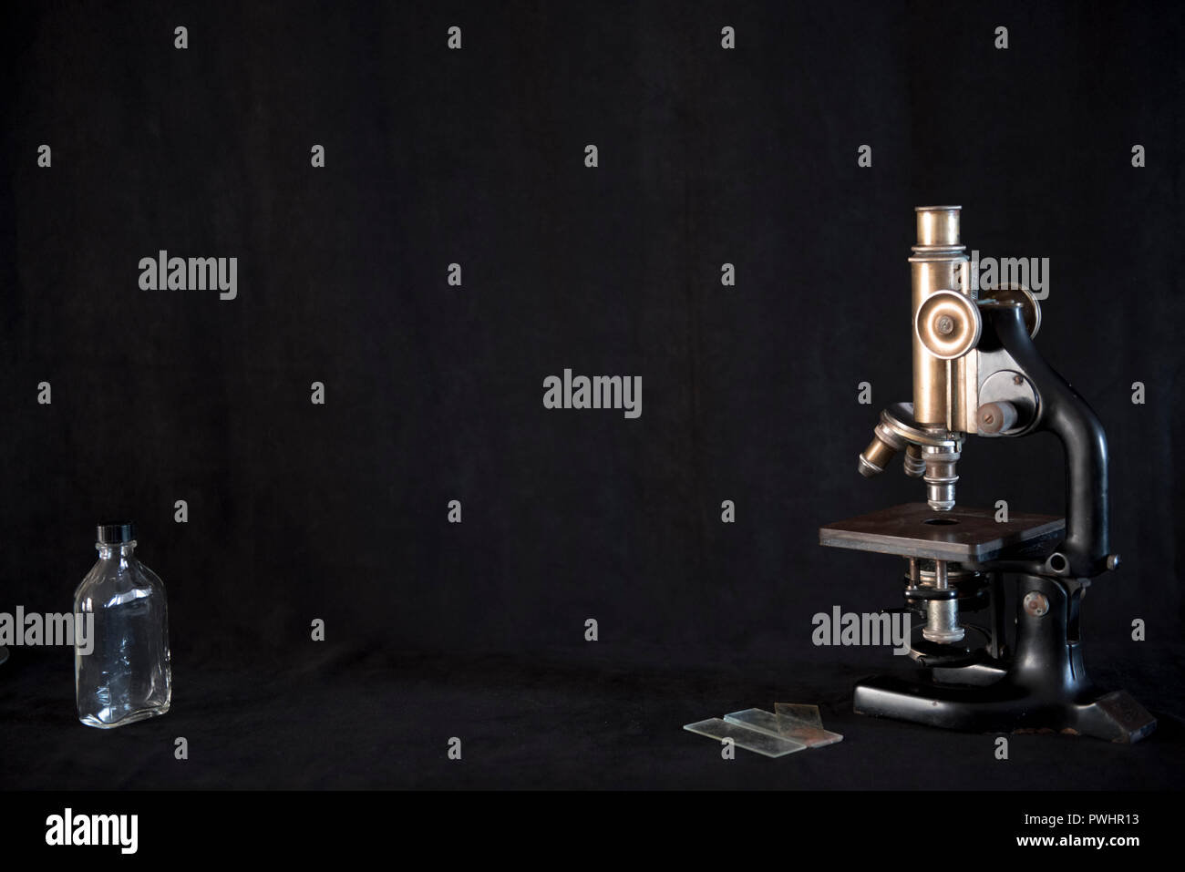 Antique Black and Brass Microscope with Antique Pill Bottle on Black ...