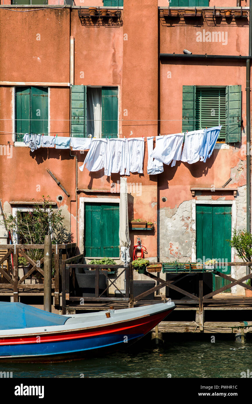 Washing lines in front of traditional buildings by the canals on ...
