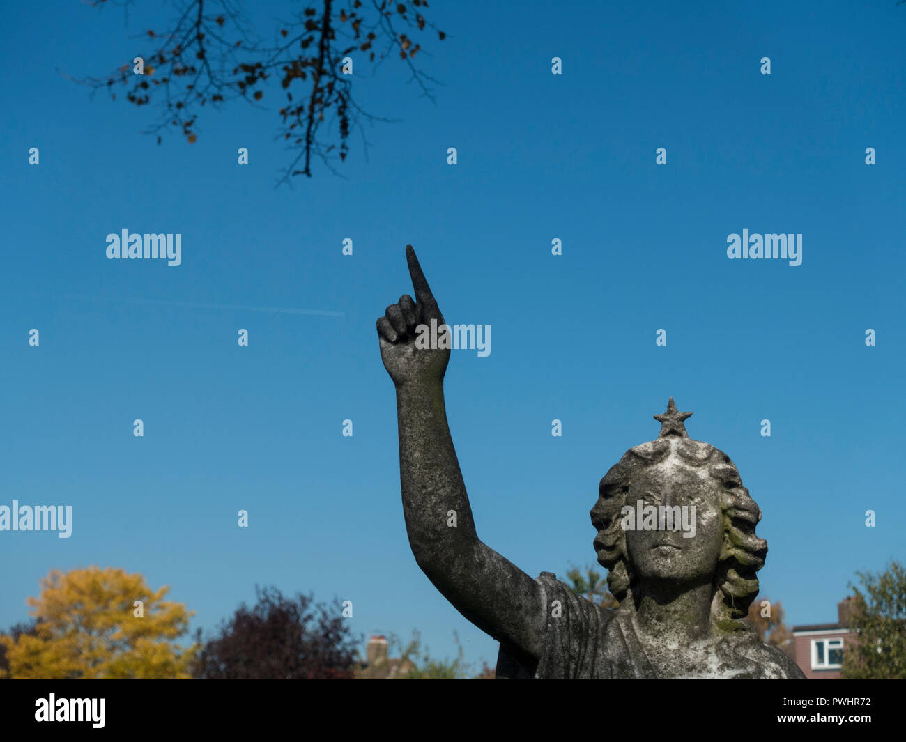 A statue pointing to the sky Stock Photo - Alamy