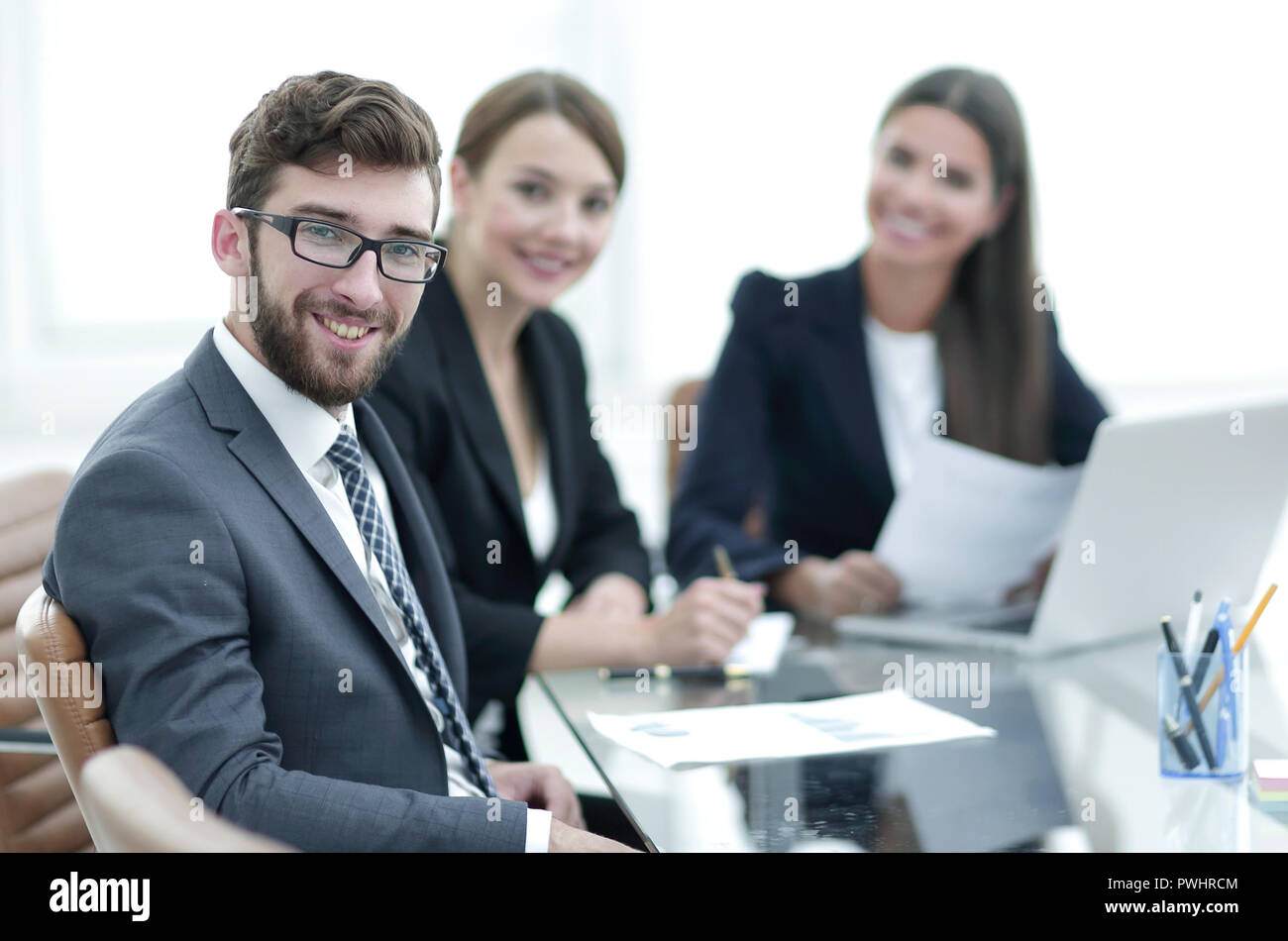 closeup.employees sitting behind a Desk.photo with copy space Stock ...