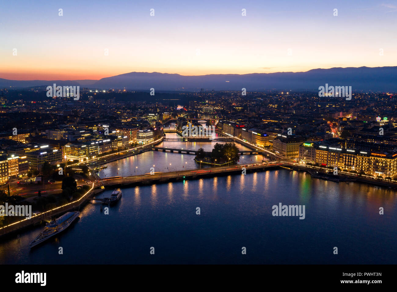 Aerial night view of Geneva city waterfront skyline in Switzerland ...