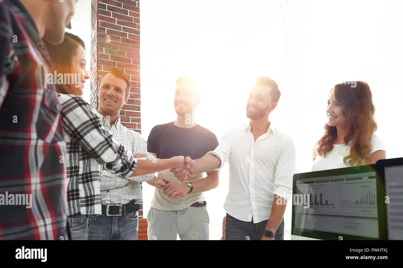 friendly handshake between Manager and employee in the creative office ...