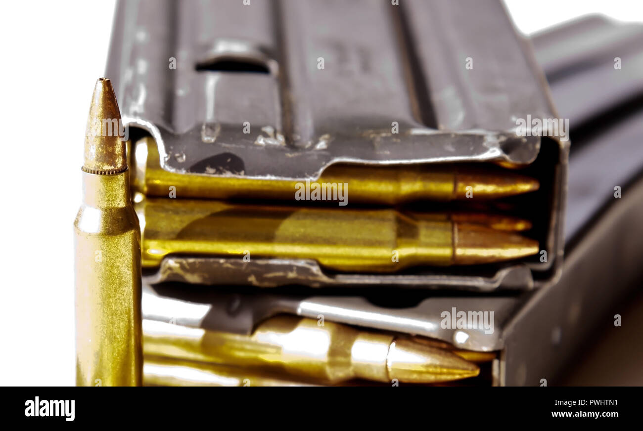 Two metal rifle magazines, one stacked upon the other, loaded with .223 ...