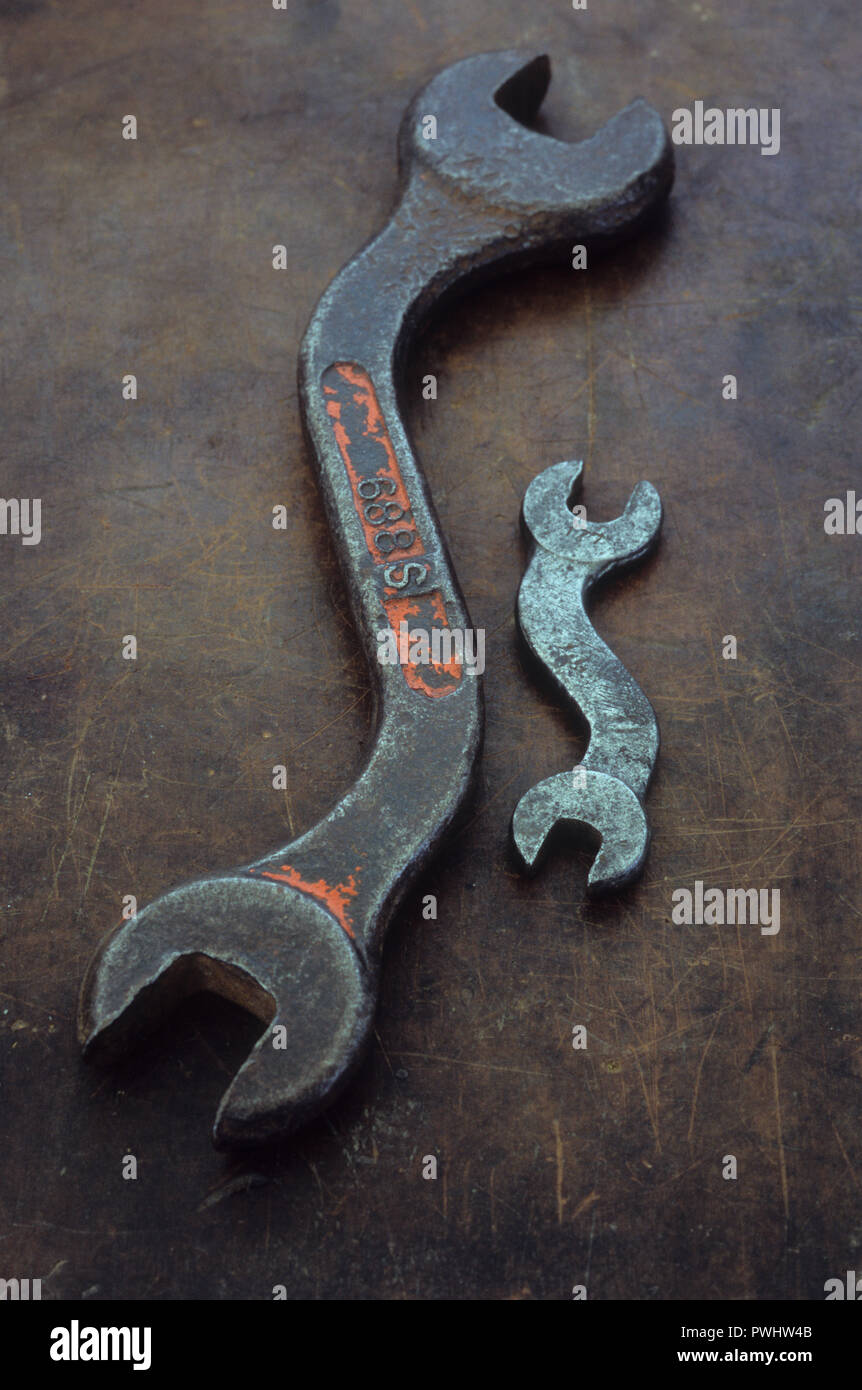 One large and one smaller spanners in gentle S shape lying together on ...