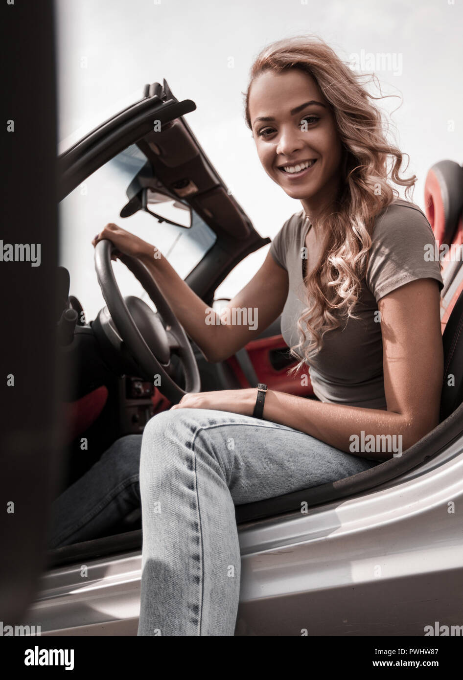 close up.stylish young woman sitting in a luxury car .side view Stock ...