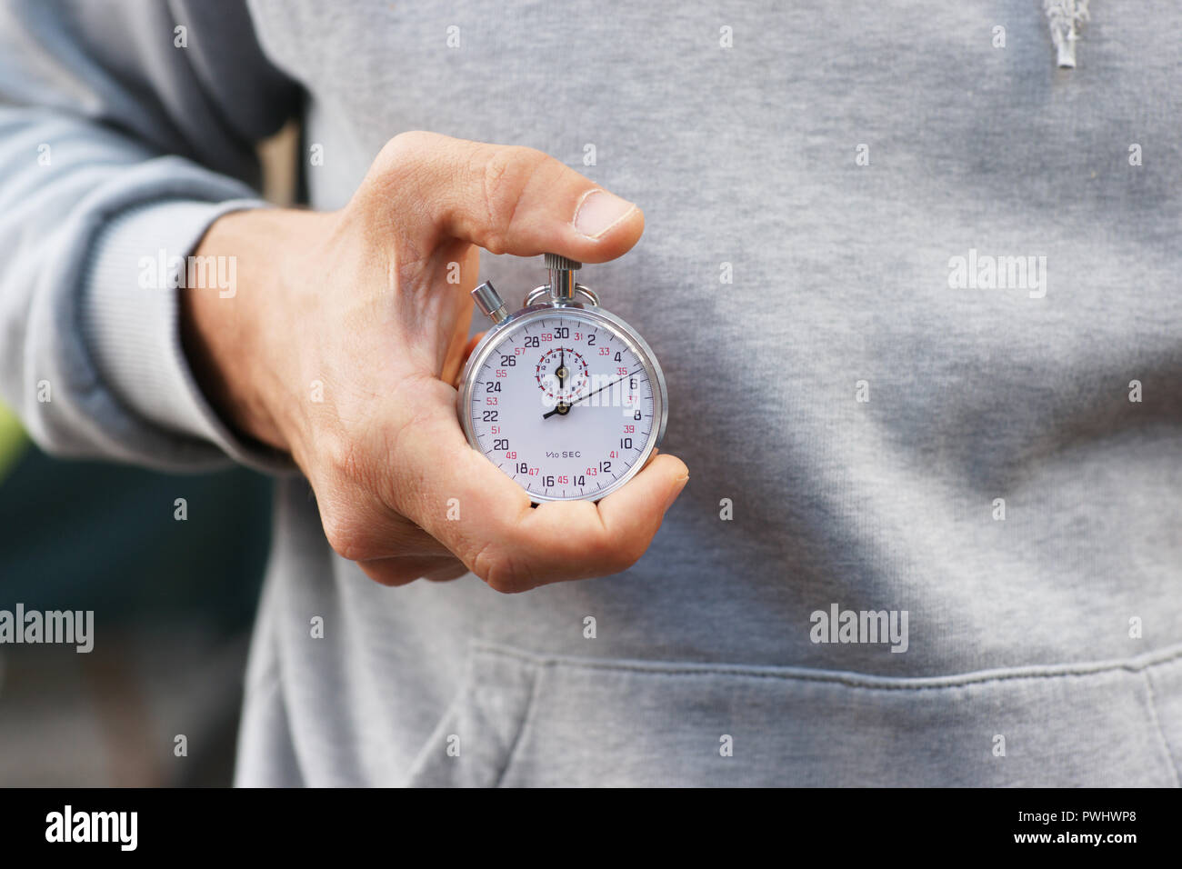 Trainer holding stopwatch - close up Stock Photo - Alamy