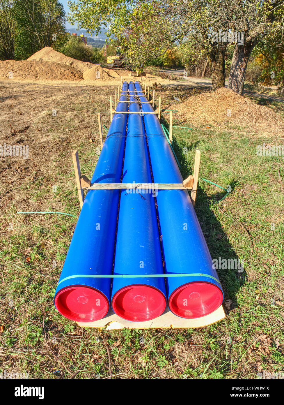 Long plastic tube on ground. Colorful thick wall of plastic pipe, bllue ...