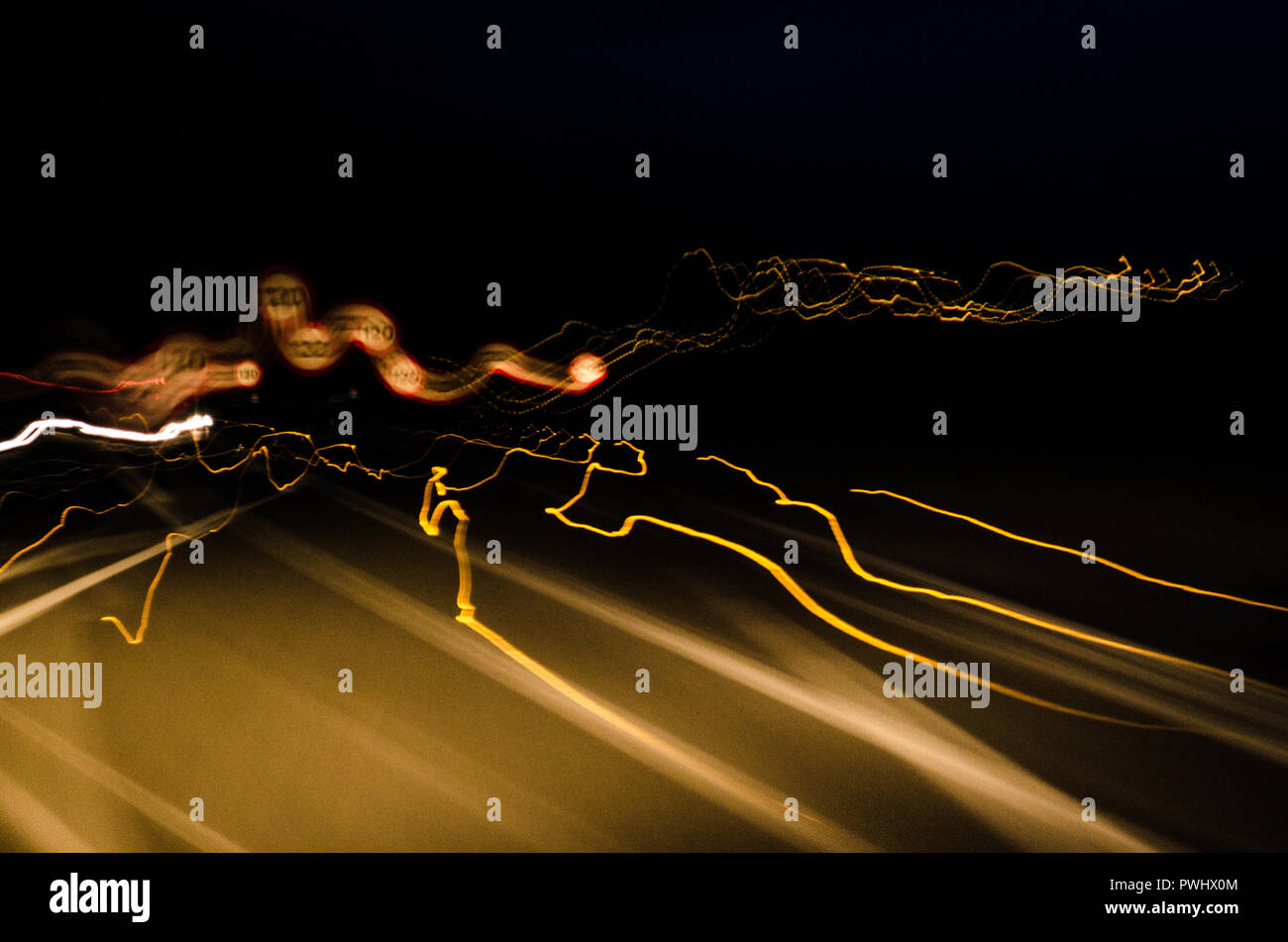 Trailing lights and traffic signals on a road Stock Photo - Alamy