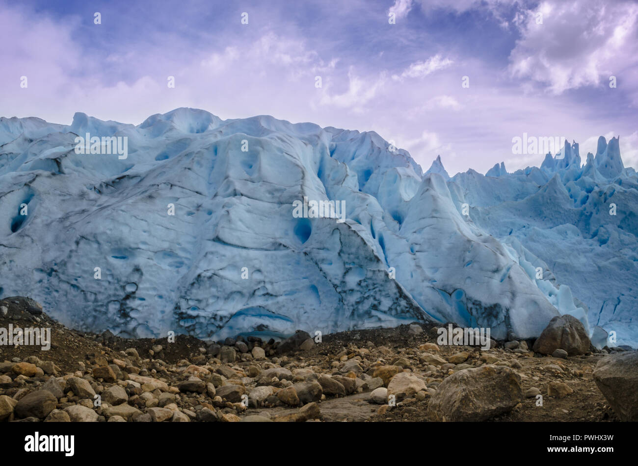 Purple sky, blue ice and brown ground. The colors of the glacier Stock ...