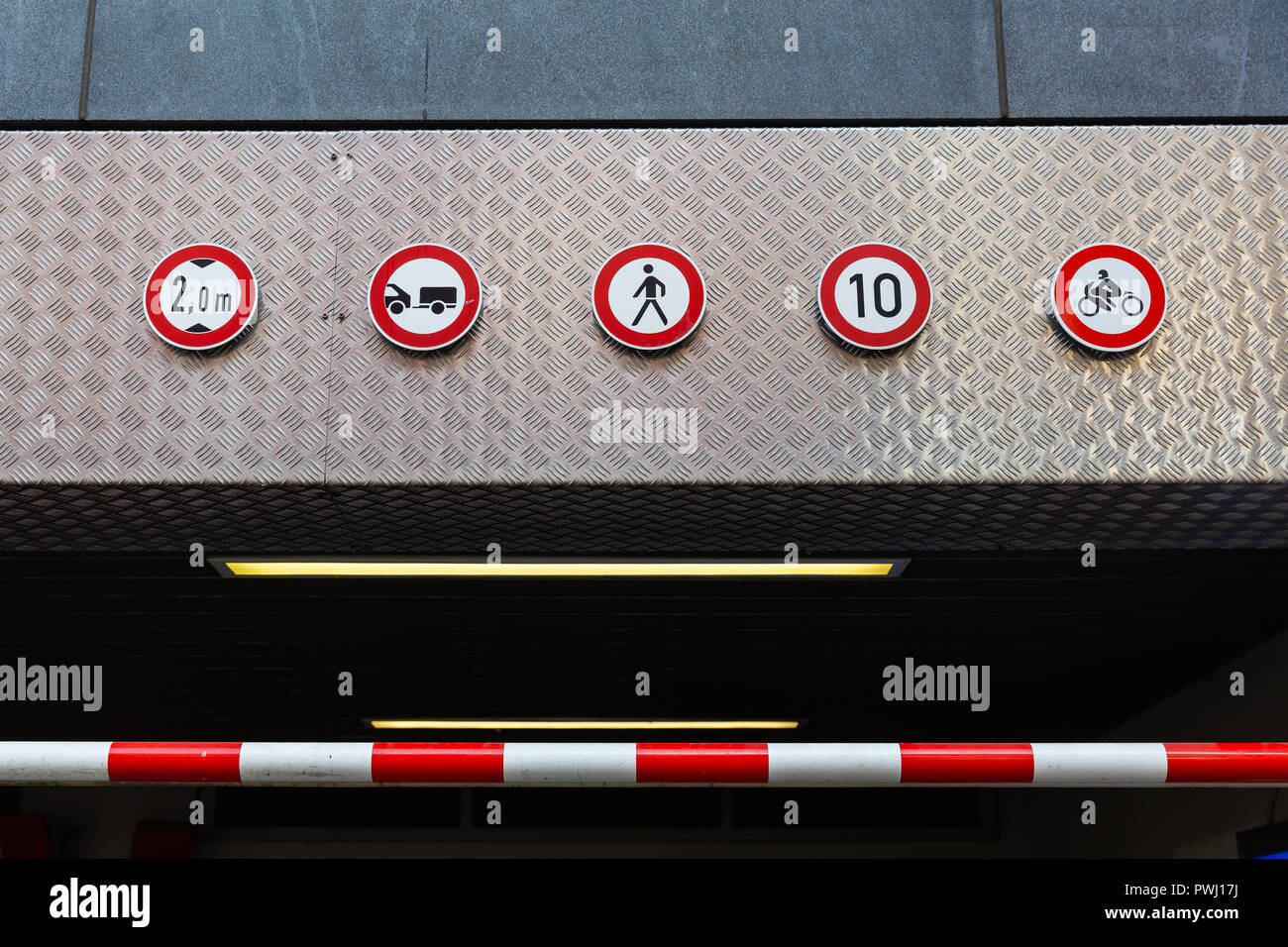 picture of traffic signs over a garage driveway Stock Photo - Alamy