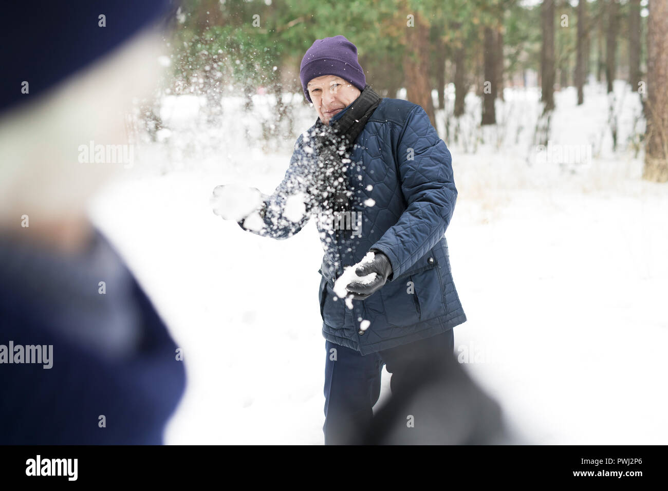Senior Man in Snowball Fight Stock Photo - Alamy
