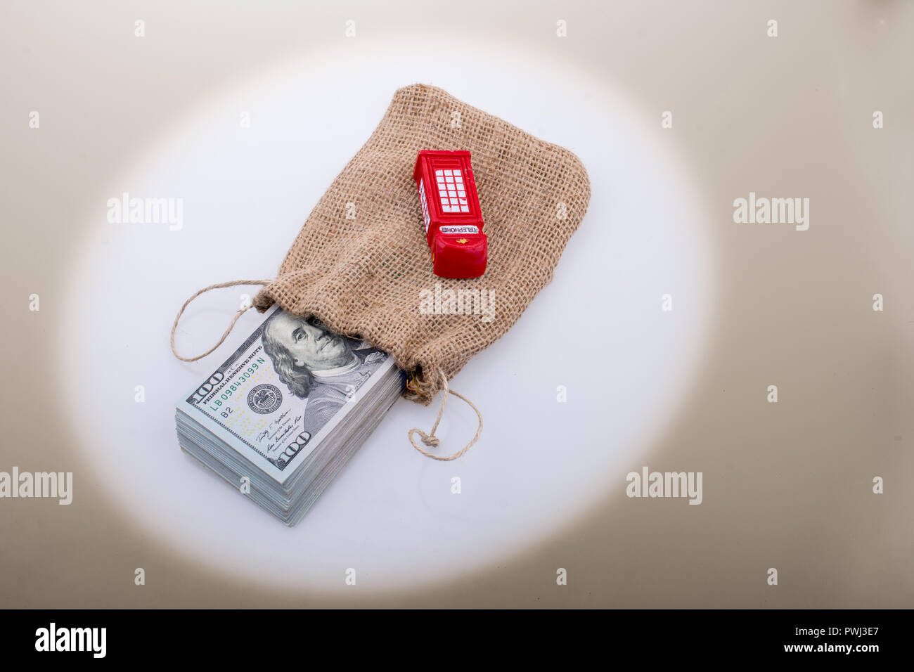 Telephone booth and banknote bundle of US dollar in a sack Stock Photo ...