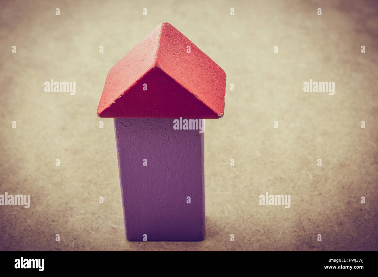 House shape formed out of building blocks on a brown background Stock ...