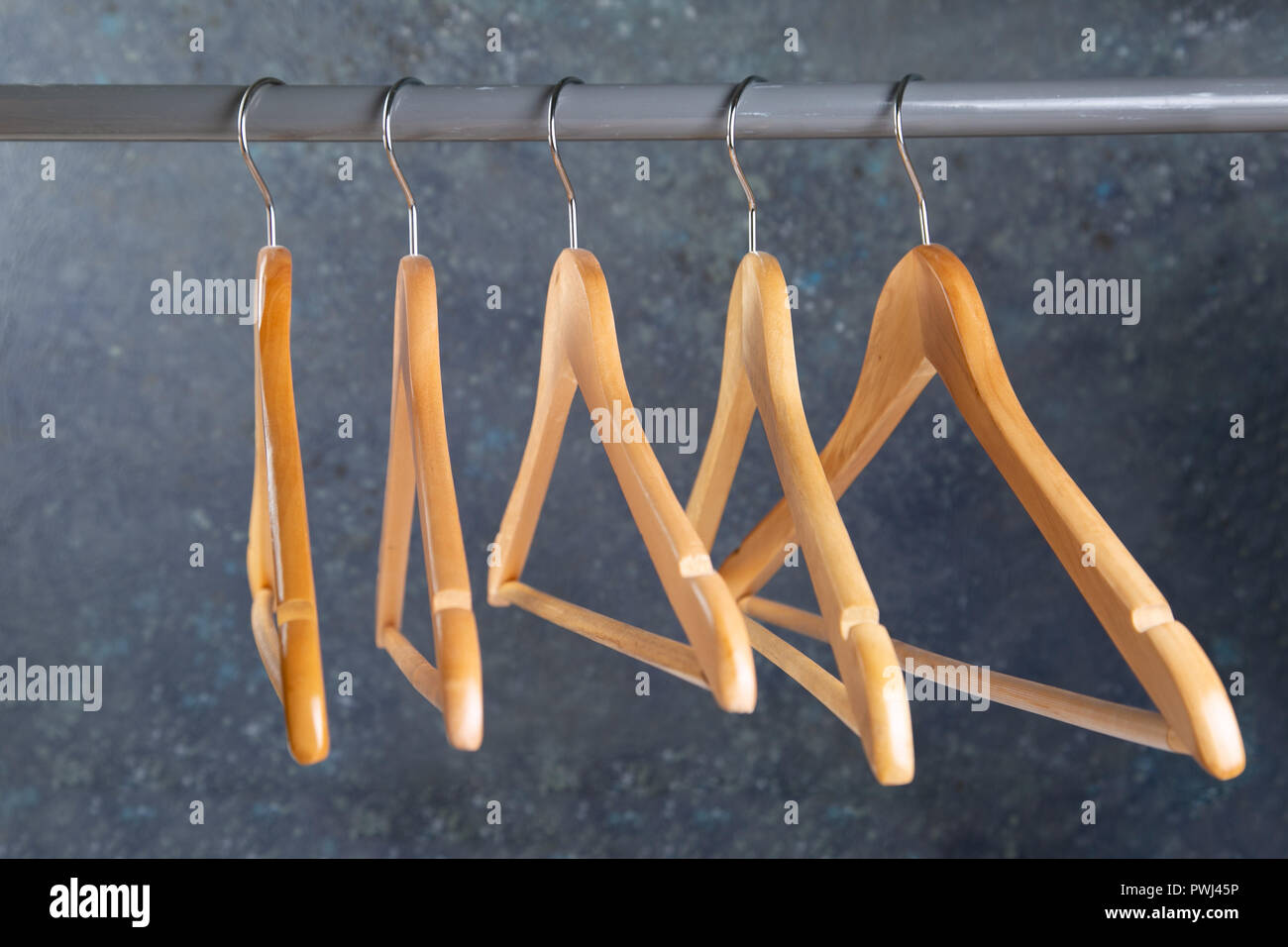Wood empty hangers on rack with rustick background Stock Photo - Alamy
