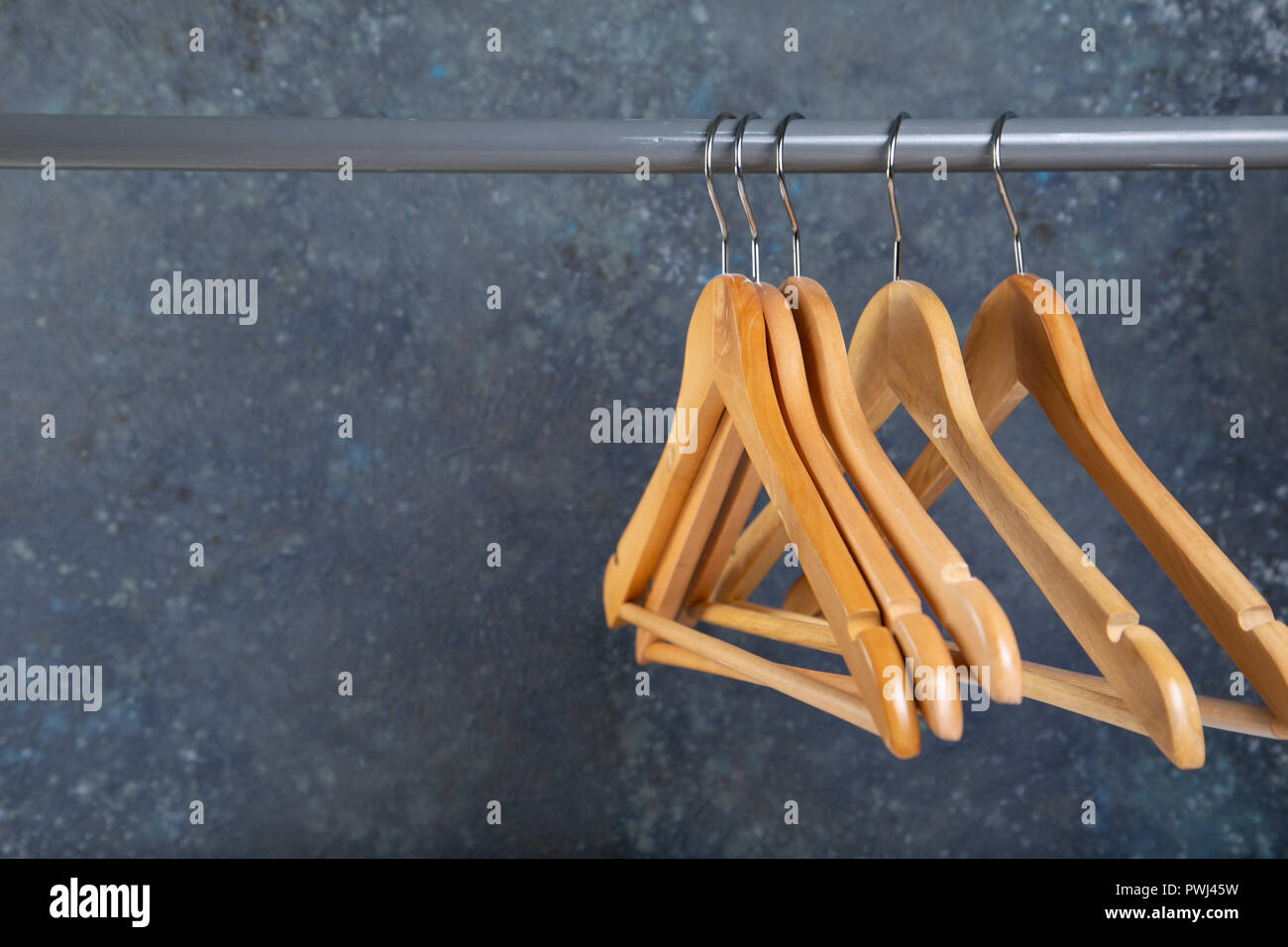 Wood empty hangers on rack with rustick background Stock Photo - Alamy