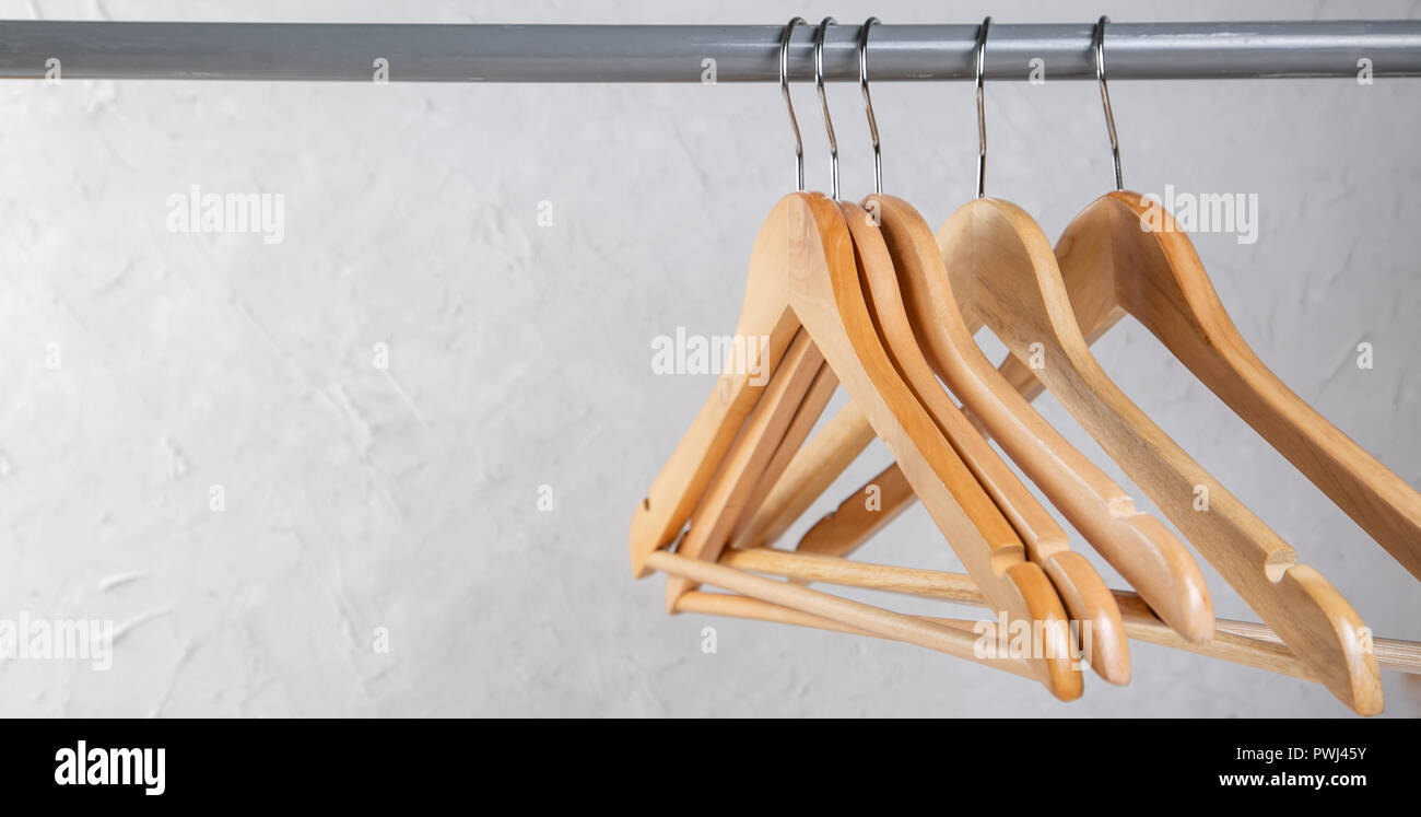 Wood empty hangers on rack with rustick background Stock Photo - Alamy