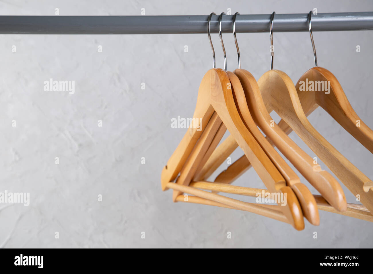 Wood empty hangers on rack with rustick background Stock Photo - Alamy