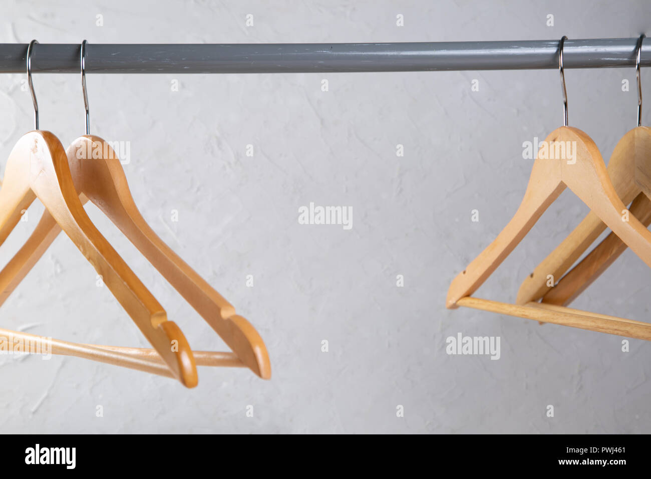 Wood empty hangers on rack with rustick background Stock Photo - Alamy