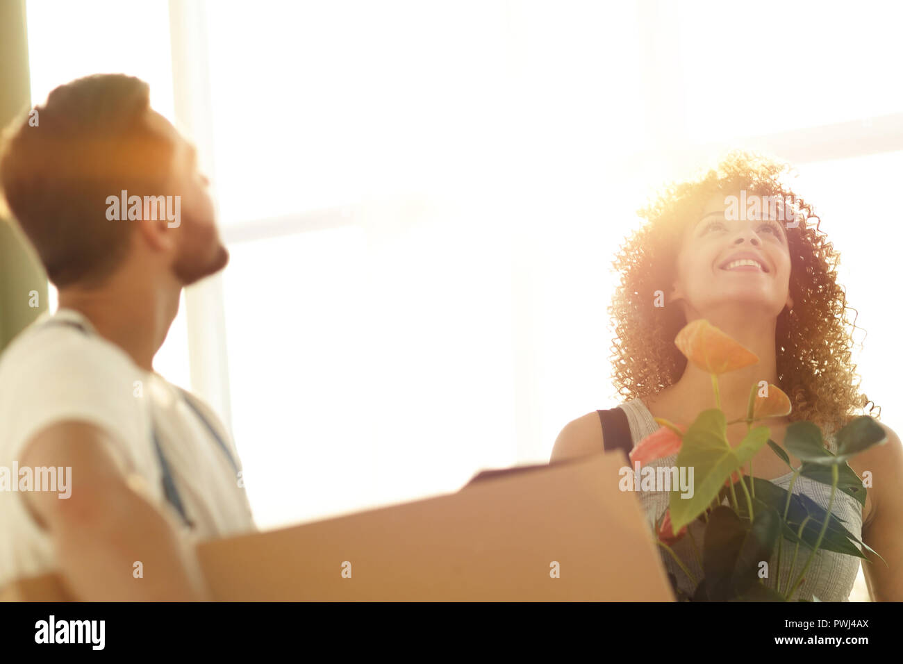 Husband and wife bring boxes with things to a new apartment Stock Photo ...