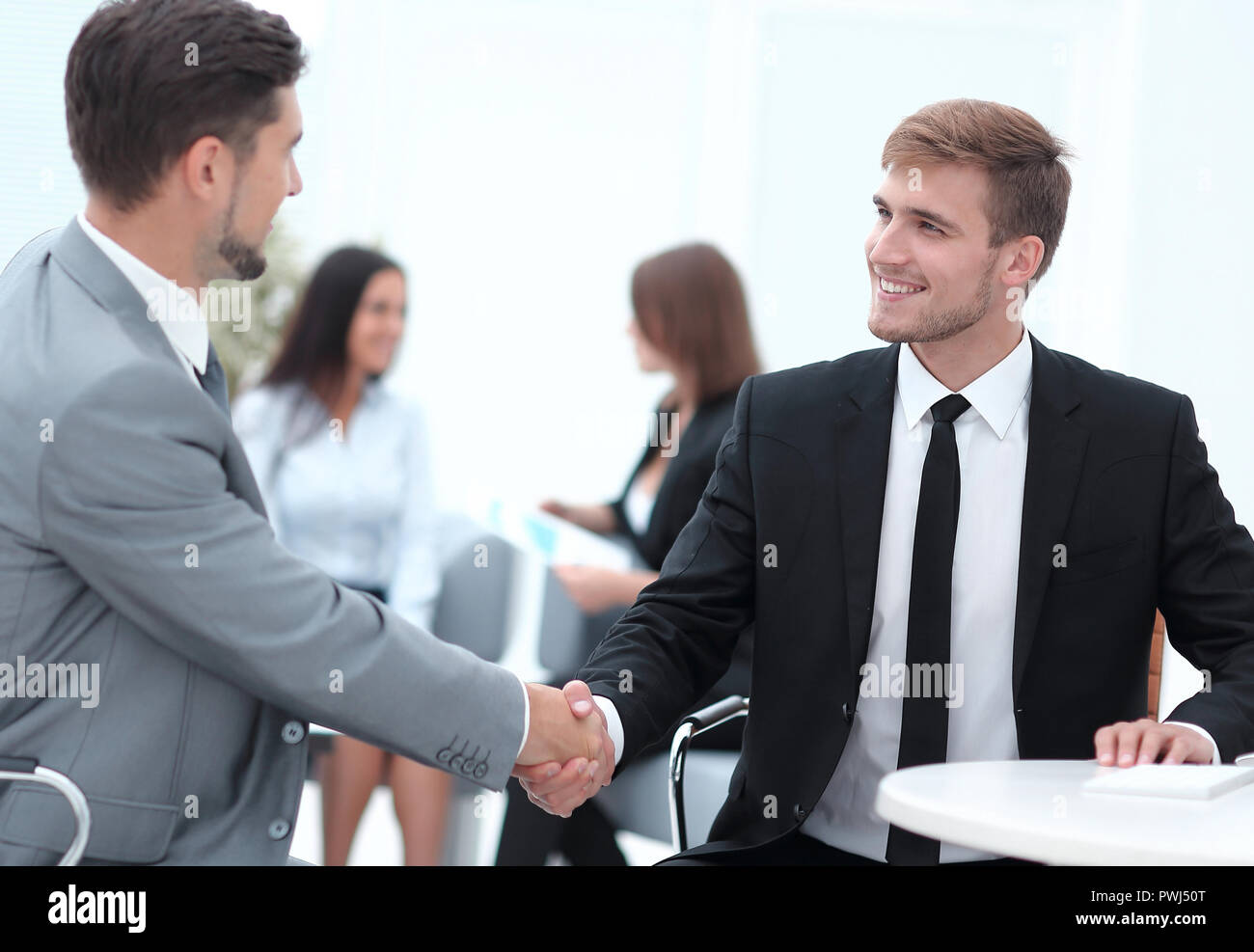 handshake Manager and the client in the office Stock Photo - Alamy