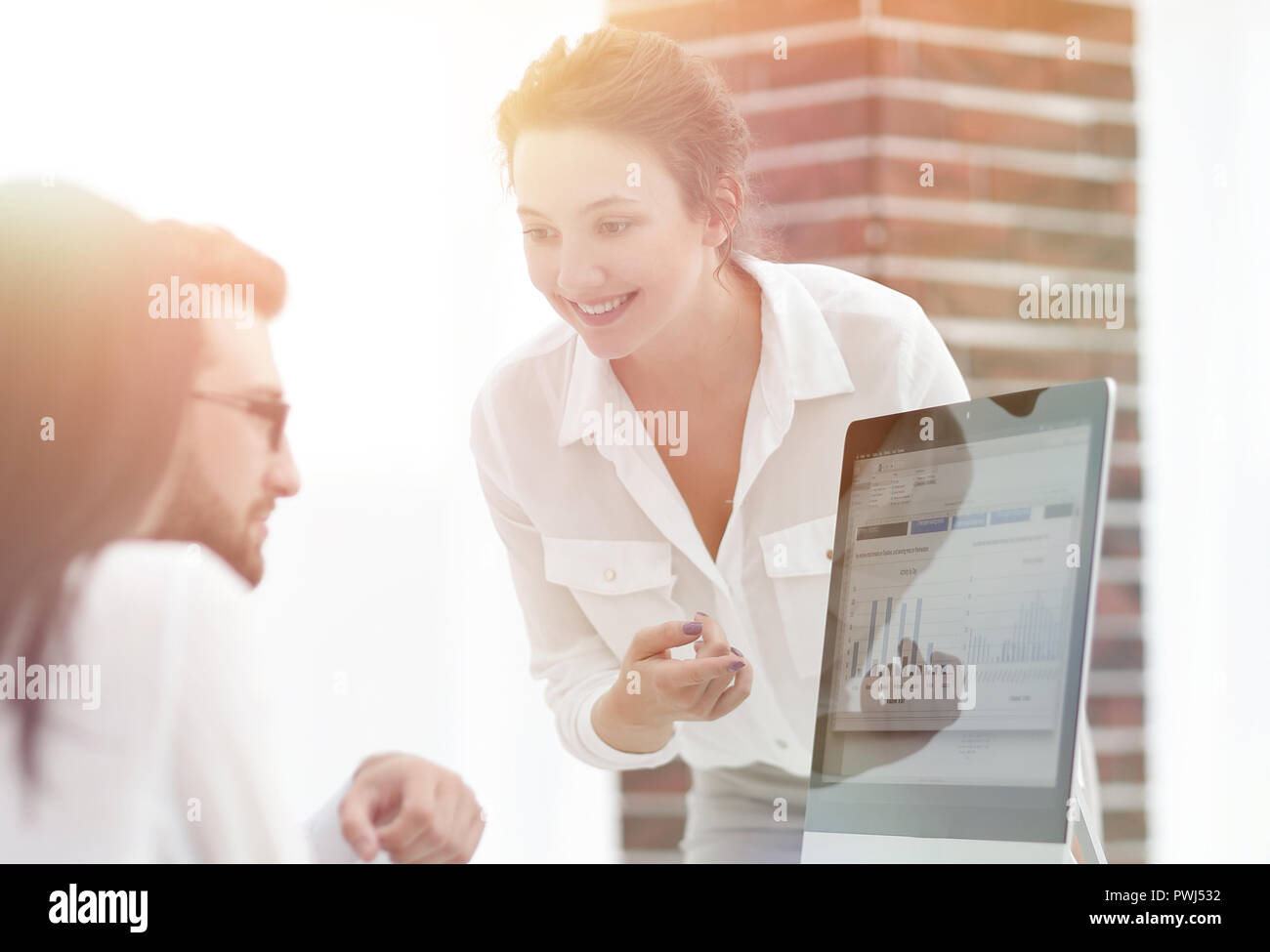 specialists of the company discussing financial schedules at the desk ...