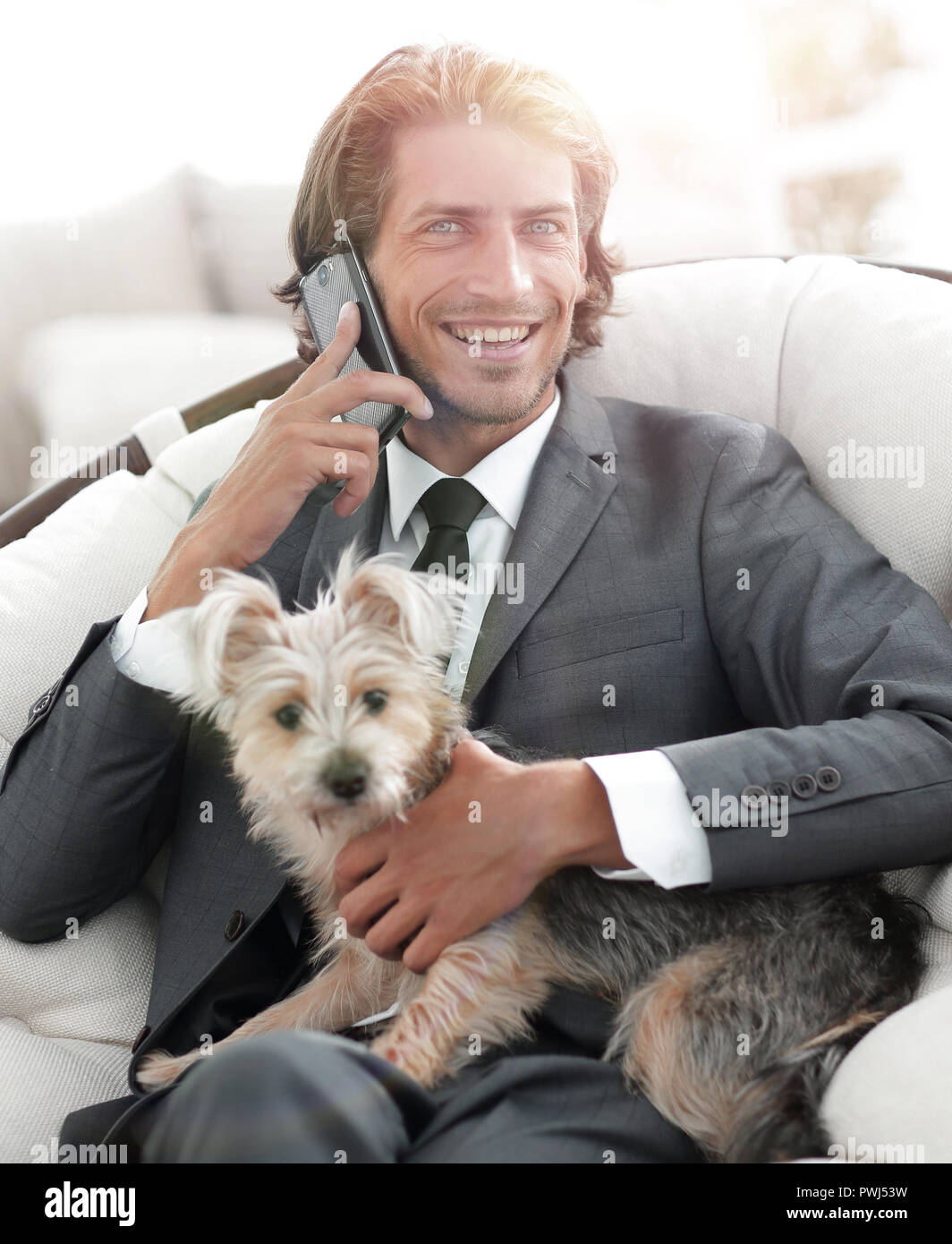 business man talking on the phone and holding his pet Stock Photo - Alamy