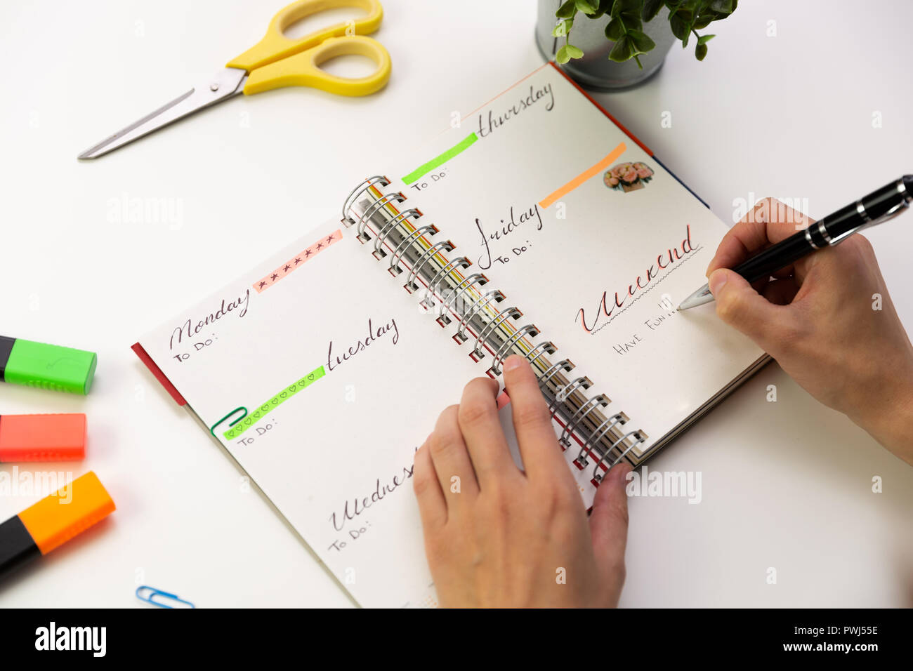 Woman's hands with pen writing in planner. Modern office desk. Working ...