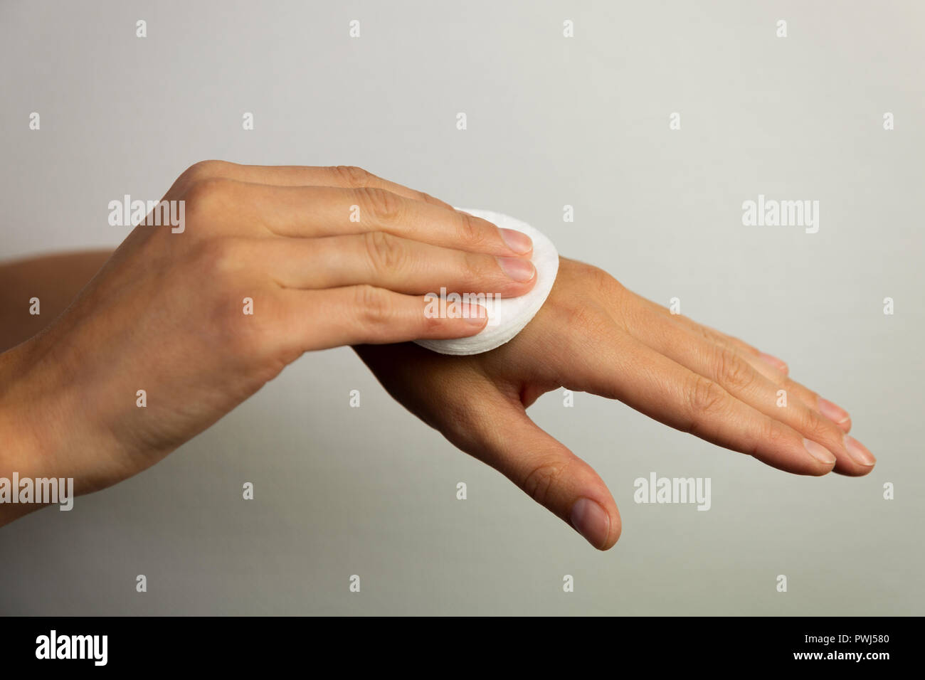 Women cleaning hands with cotton pad Stock Photo - Alamy
