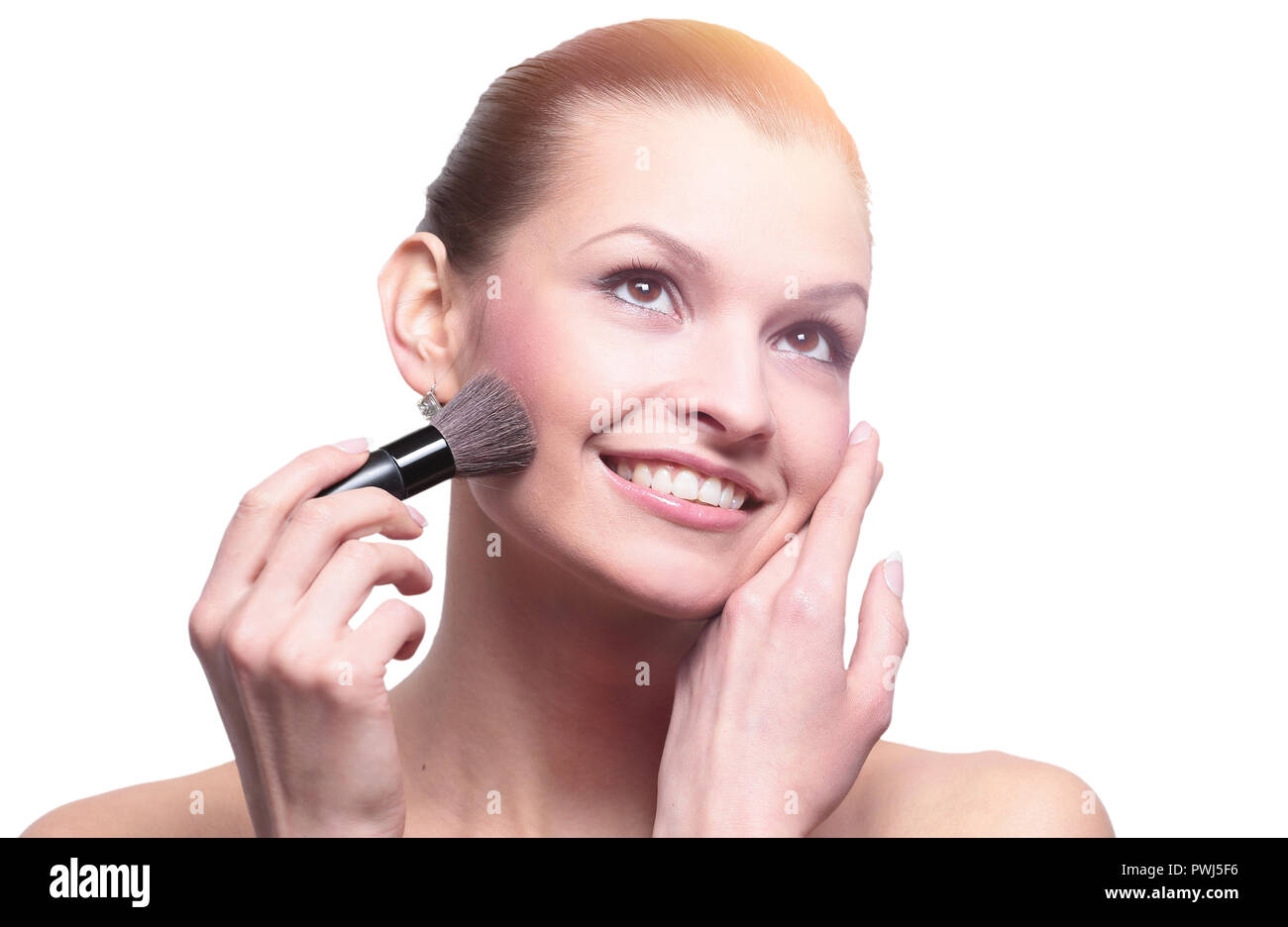 Woman applying dry cosmetic tonal foundation on the face using m Stock ...