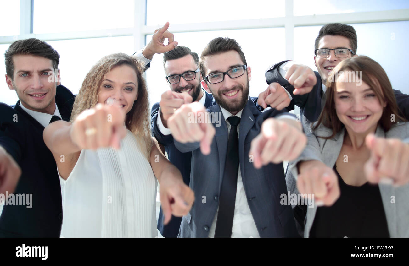 close up. smiling business team pointing at you Stock Photo - Alamy